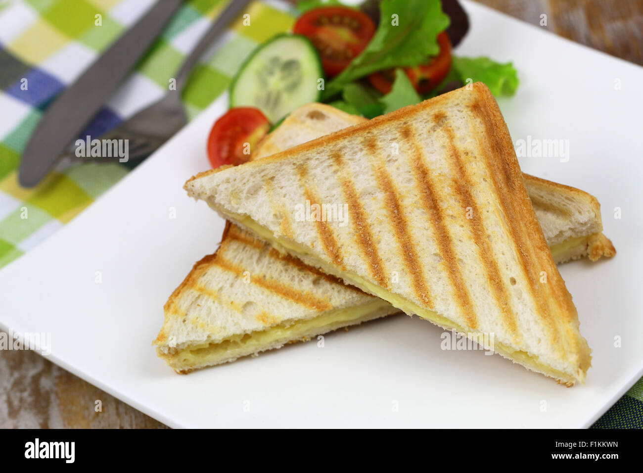 Toast with cheese and green salad, closeup Stock Photo - Alamy