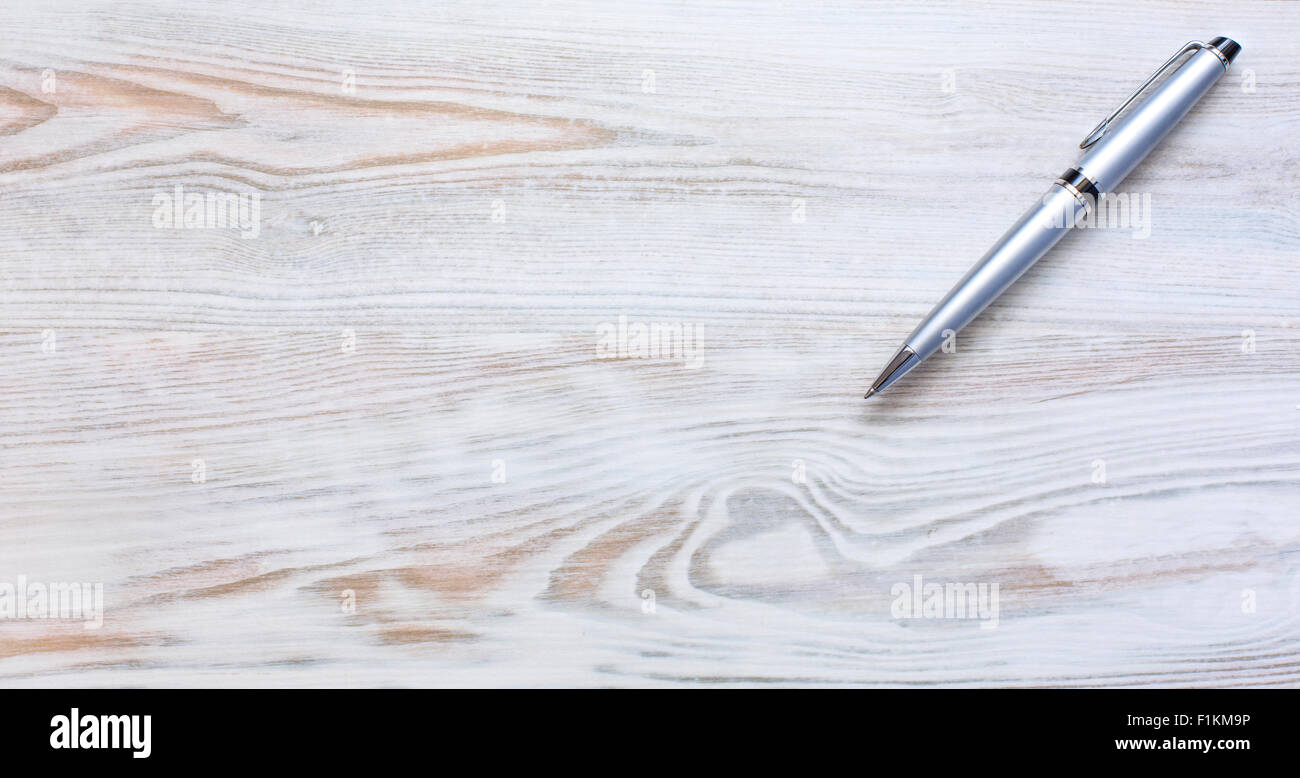 Wooded desk with executive style pen Stock Photo - Alamy