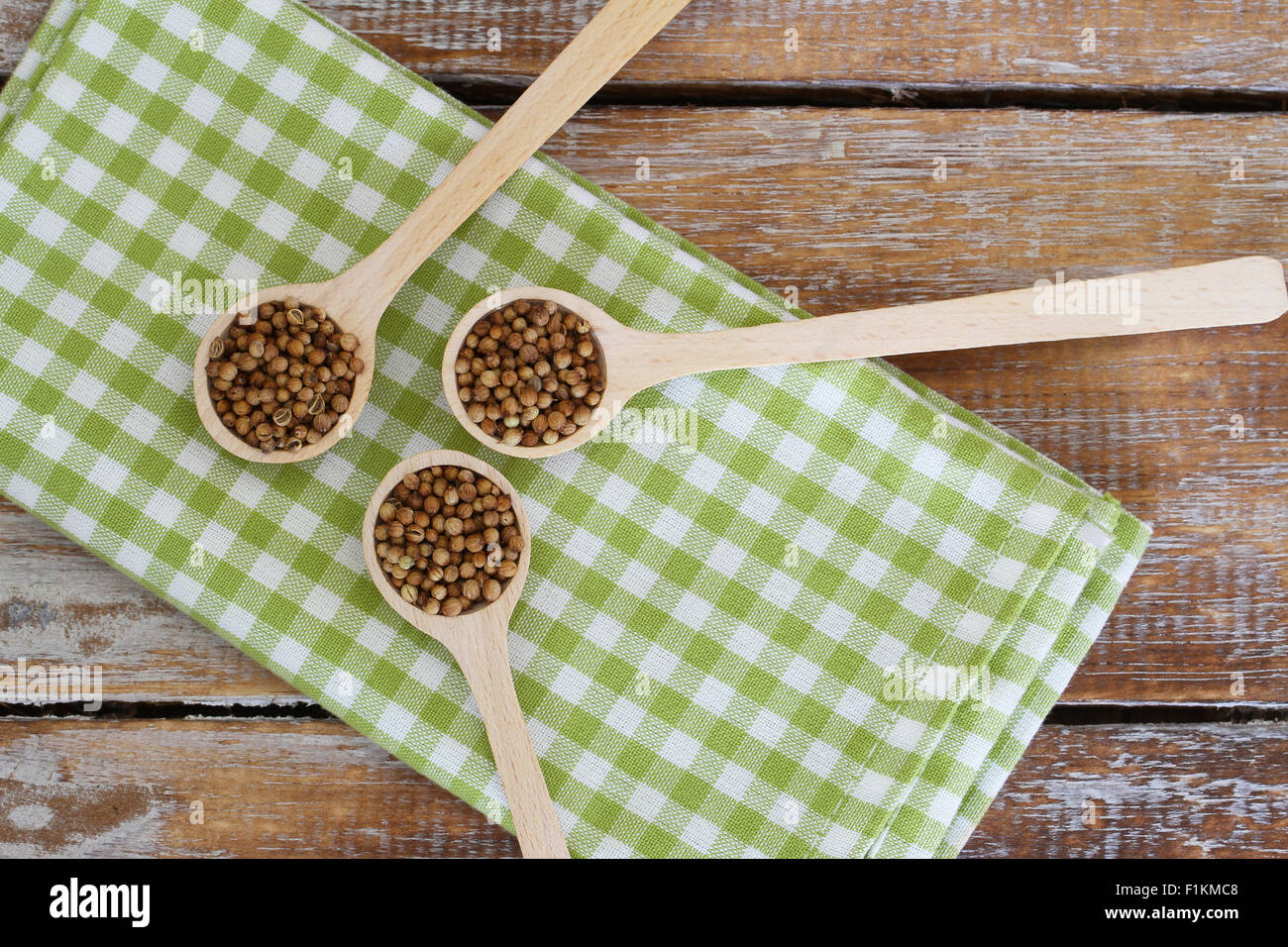 Coriander seeds on wooden spoons on checkered cloth Stock Photo - Alamy