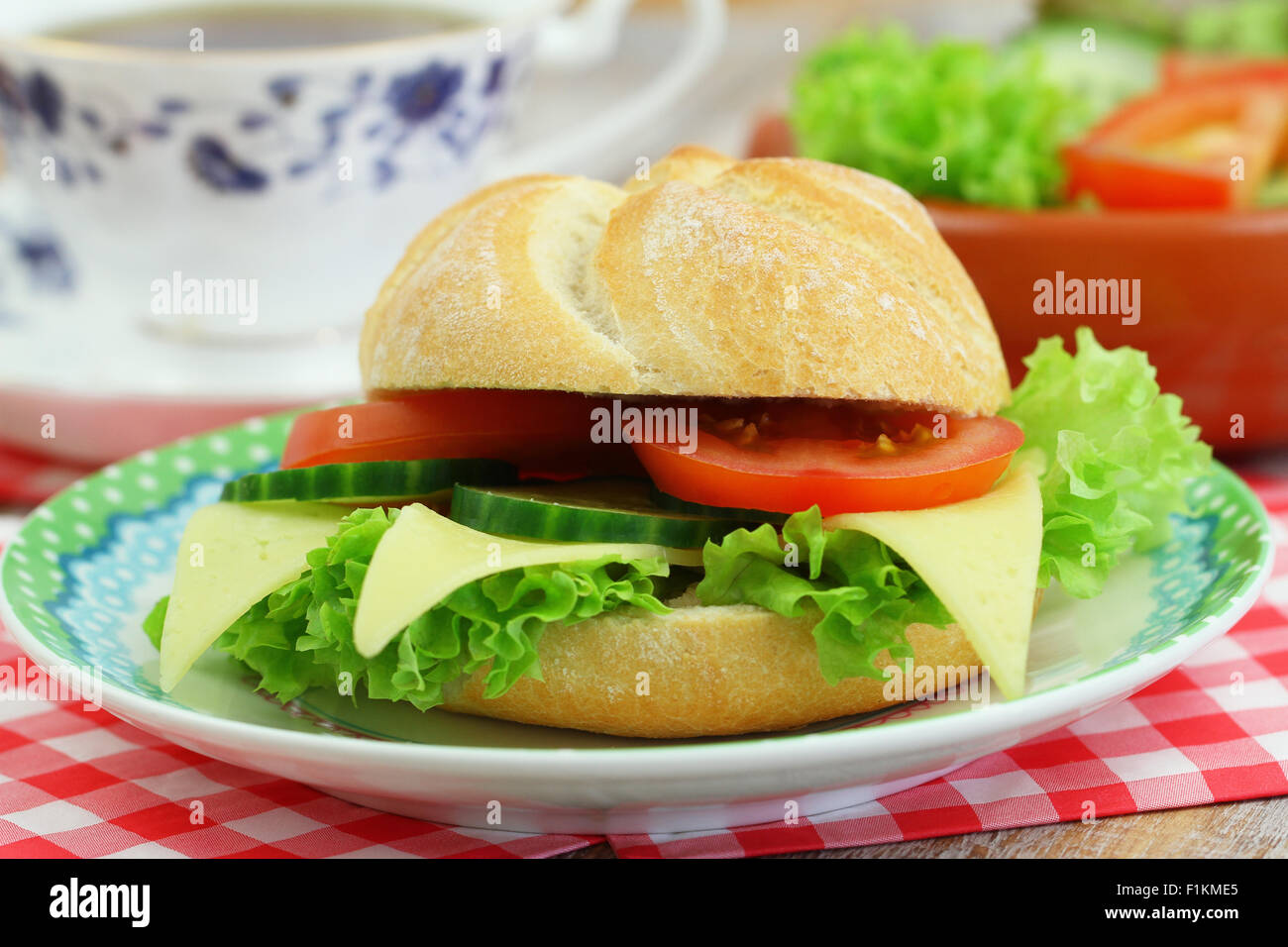 Cheese roll with lettuce, tomato and cucumber and cup of tea Stock ...