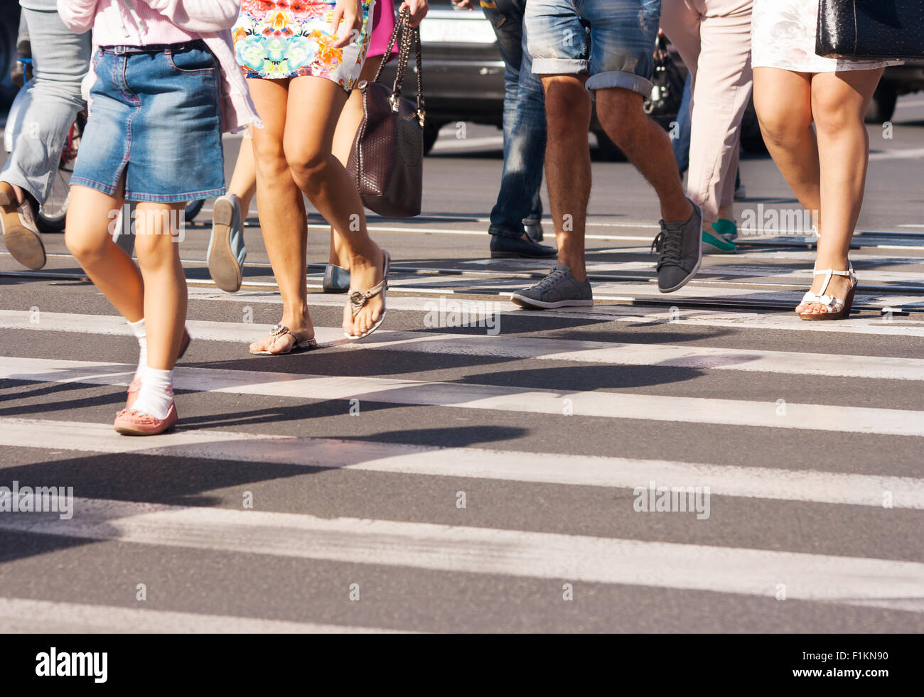 feet of the pedestrians crossing on city street closeup Stock Photo - Alamy