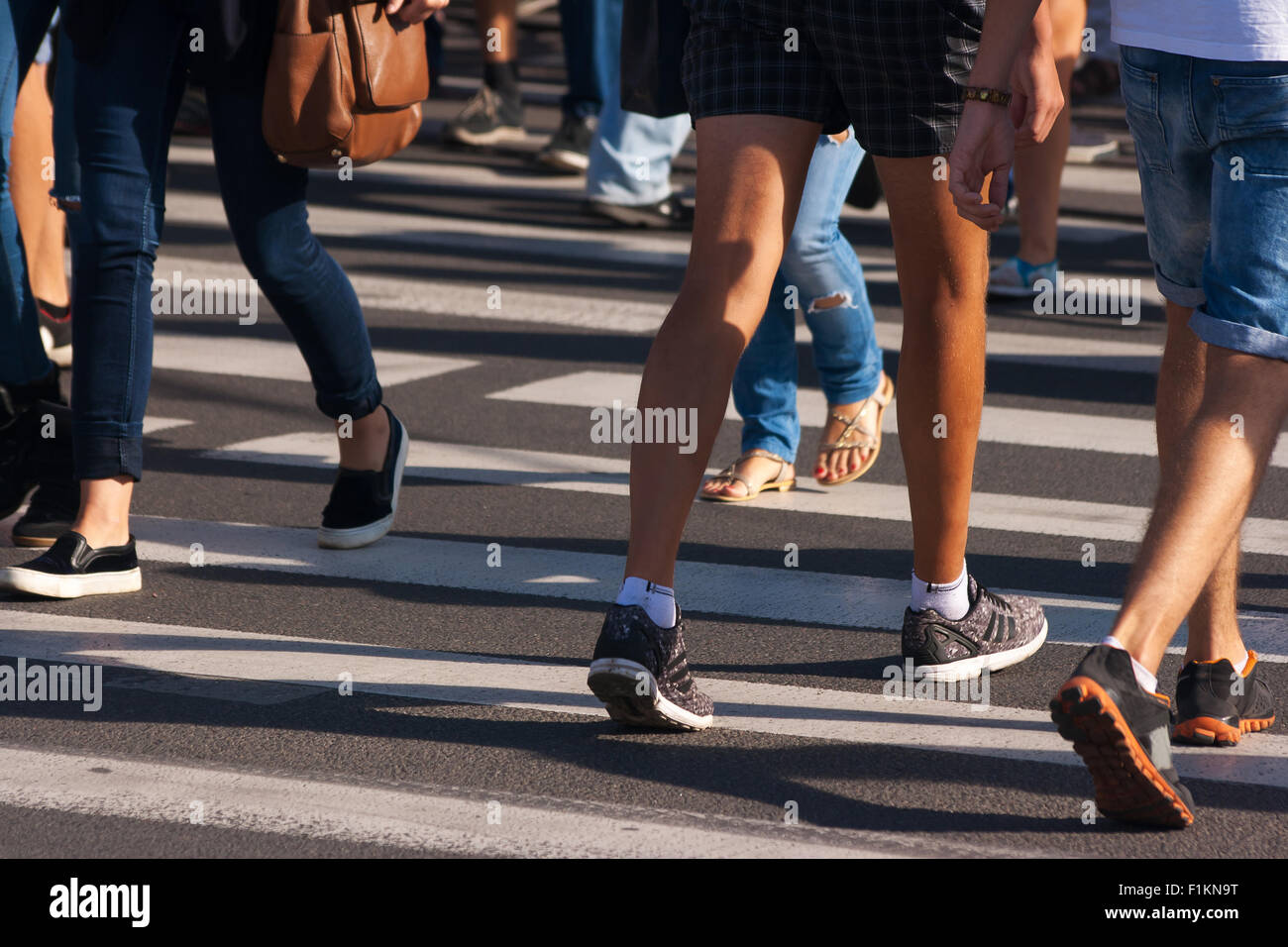 feet of pedestrians walking on the crosswalk on city road Stock Photo ...