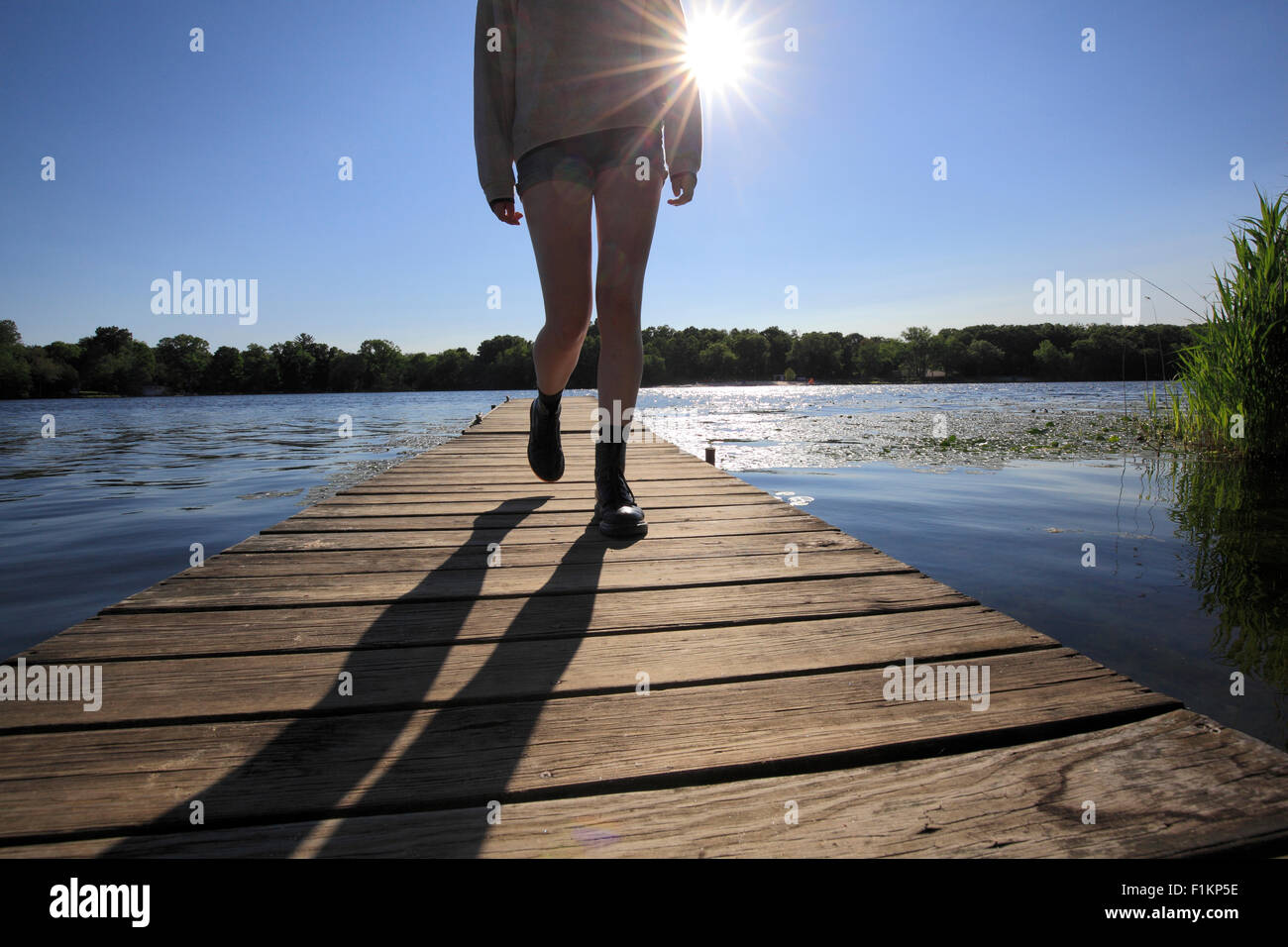 Girl walking on dock lake hi-res stock photography and images - Alamy