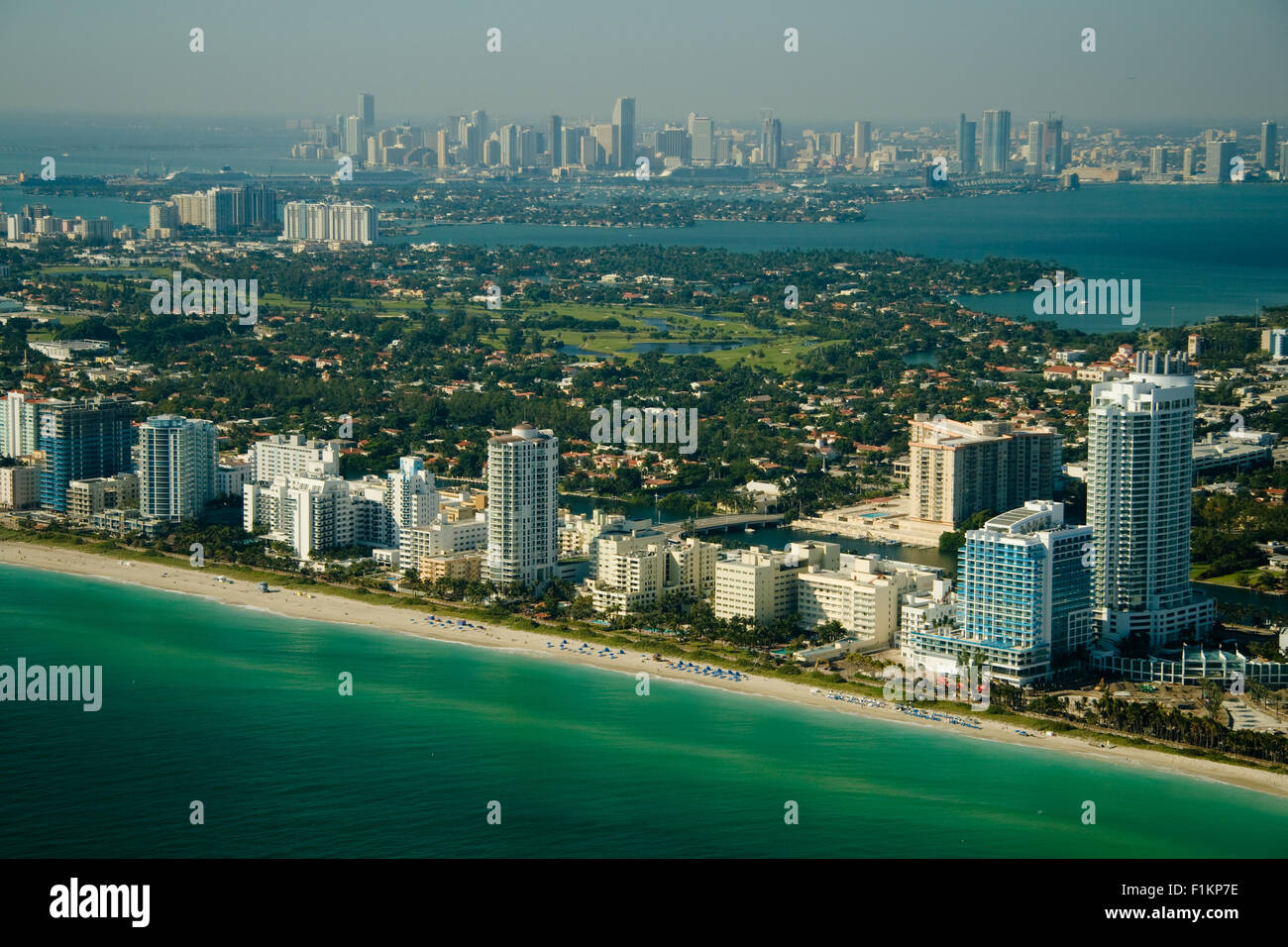 An aerial view of the seashore in Miami with deep green and blue waters ...