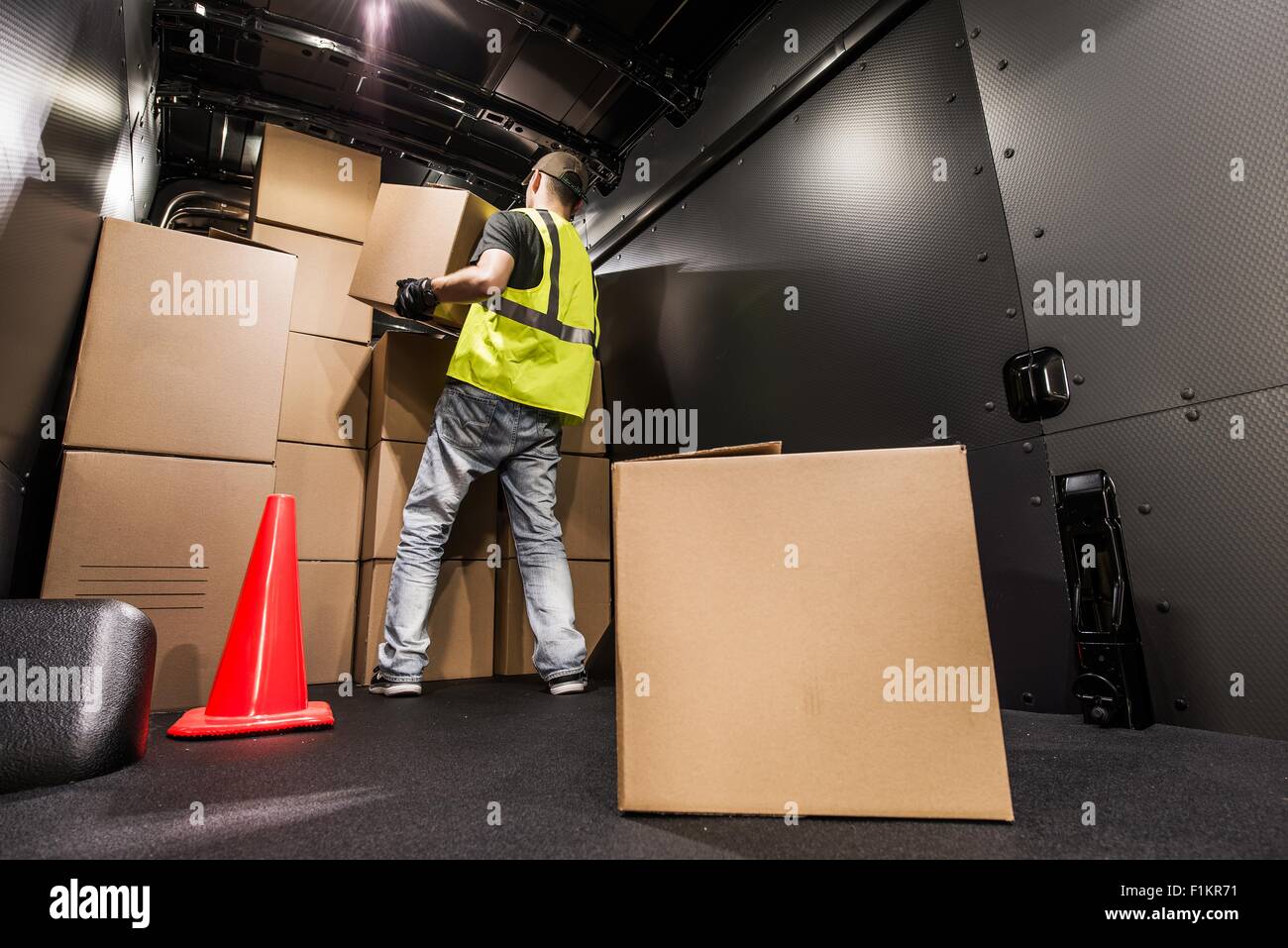 Cargo Van Loading by Worker. Man Carrying Boxes In the Cargo Van For ...