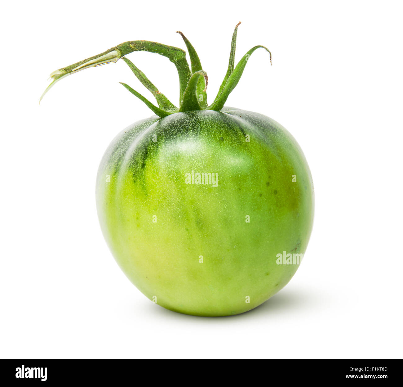 Single green tomato isolated on white background Stock Photo - Alamy