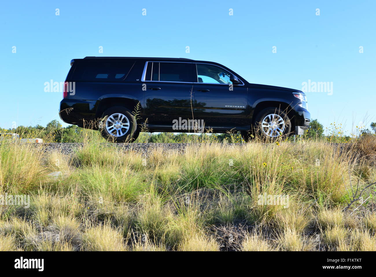 Chevrolet Suburban parked by the side of the road Stock Photo - Alamy