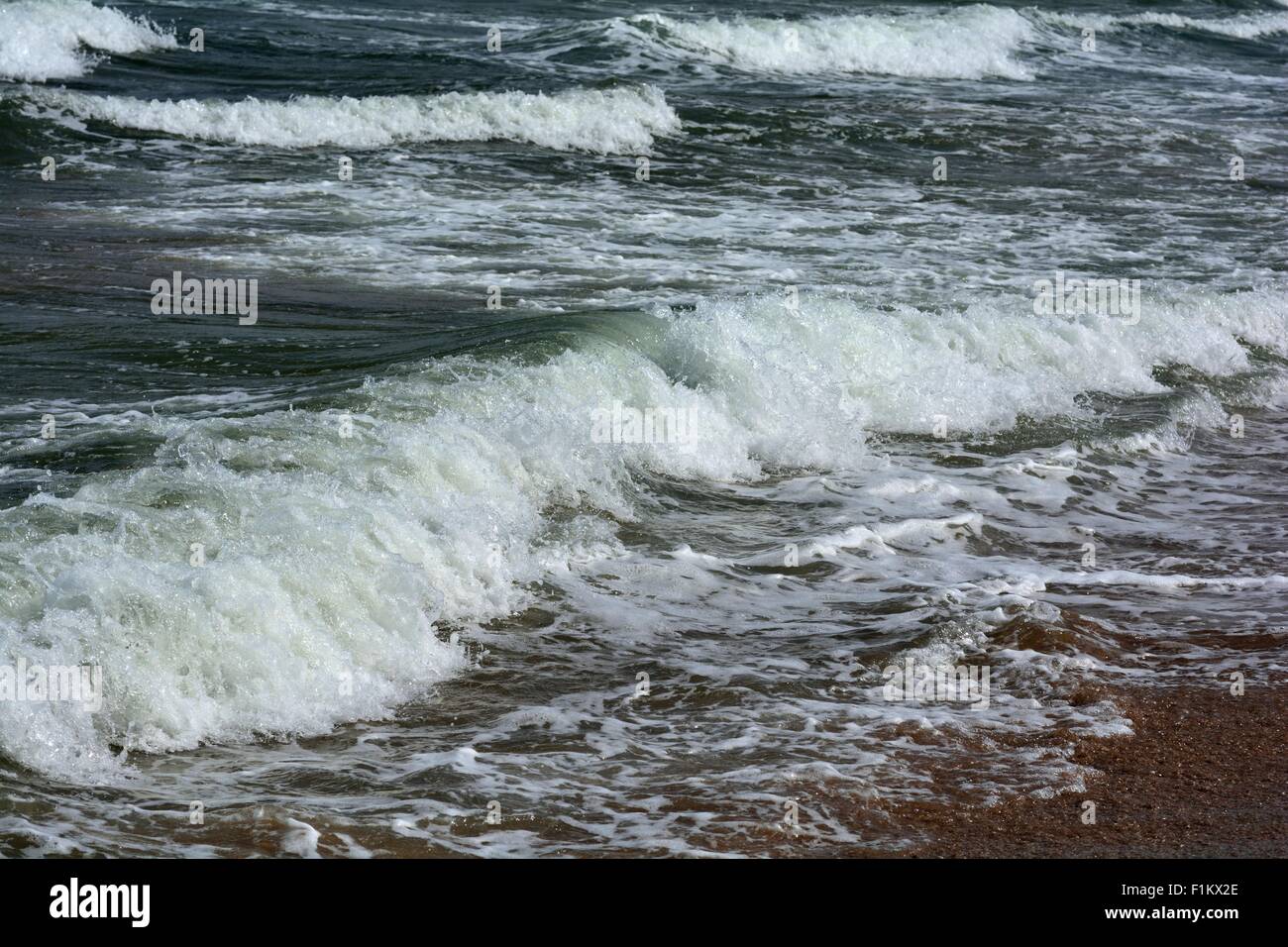 Sand and waves Stock Photo - Alamy