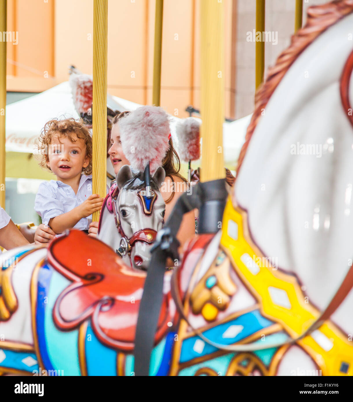 Baby boy having fun in a carousel Stock Photo - Alamy