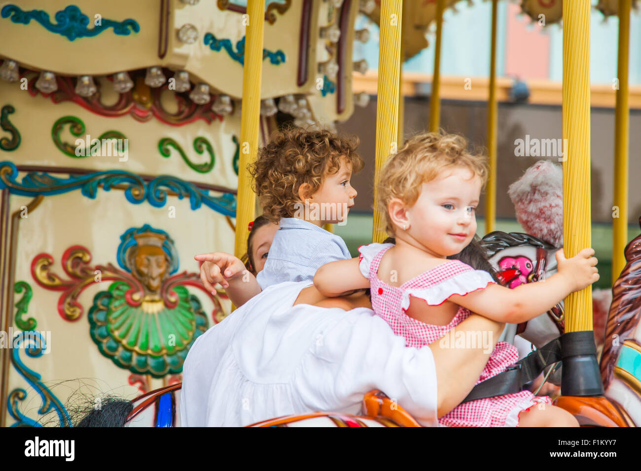 Baby boy having fun in a carousel Stock Photo - Alamy