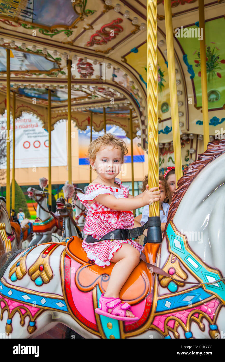 Baby boy having fun in a carousel Stock Photo - Alamy
