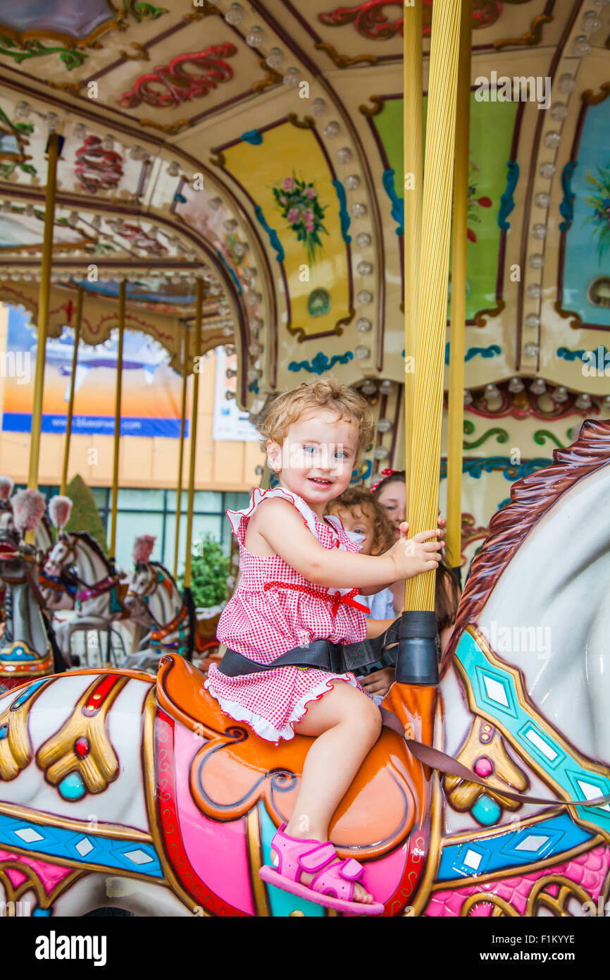 Baby boy having fun in a carousel Stock Photo - Alamy