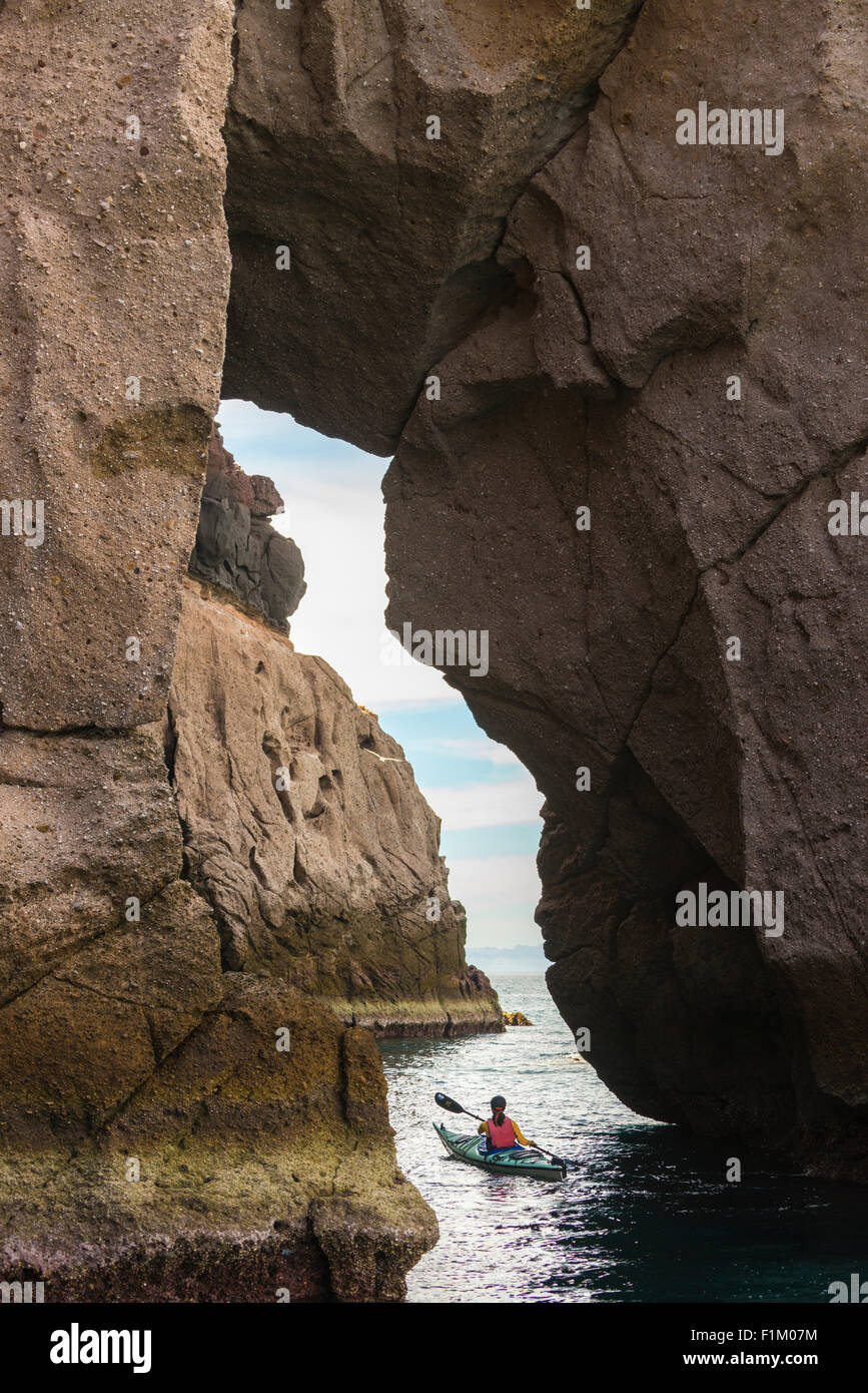 Mexico, Baja, Lapaz, Espiritu Santo. Woman kayaking through caves Stock ...