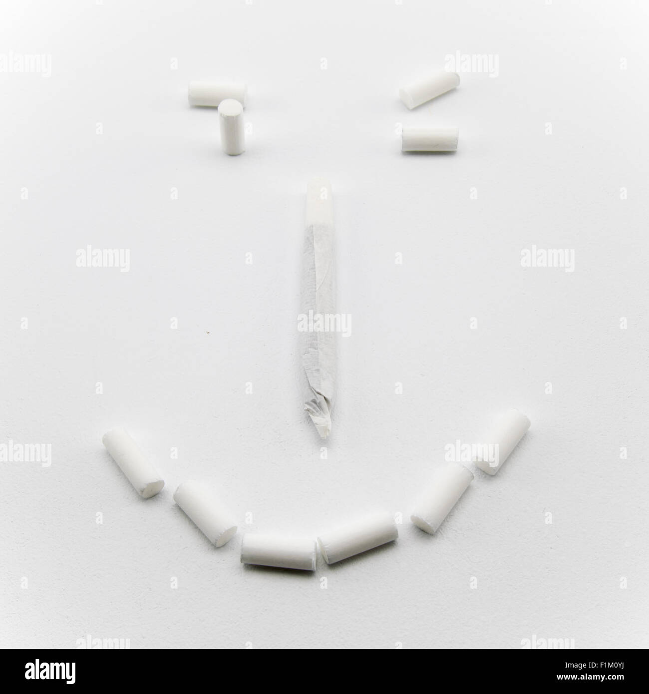 Hand made cigarette and some filters are smiling Stock Photo - Alamy