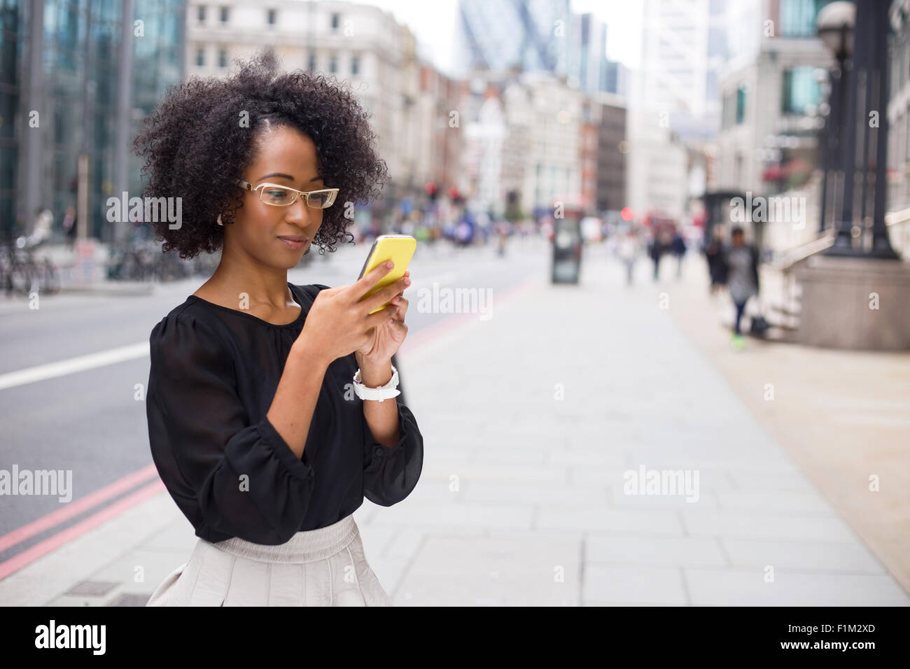 young woman sending a text message Stock Photo - Alamy