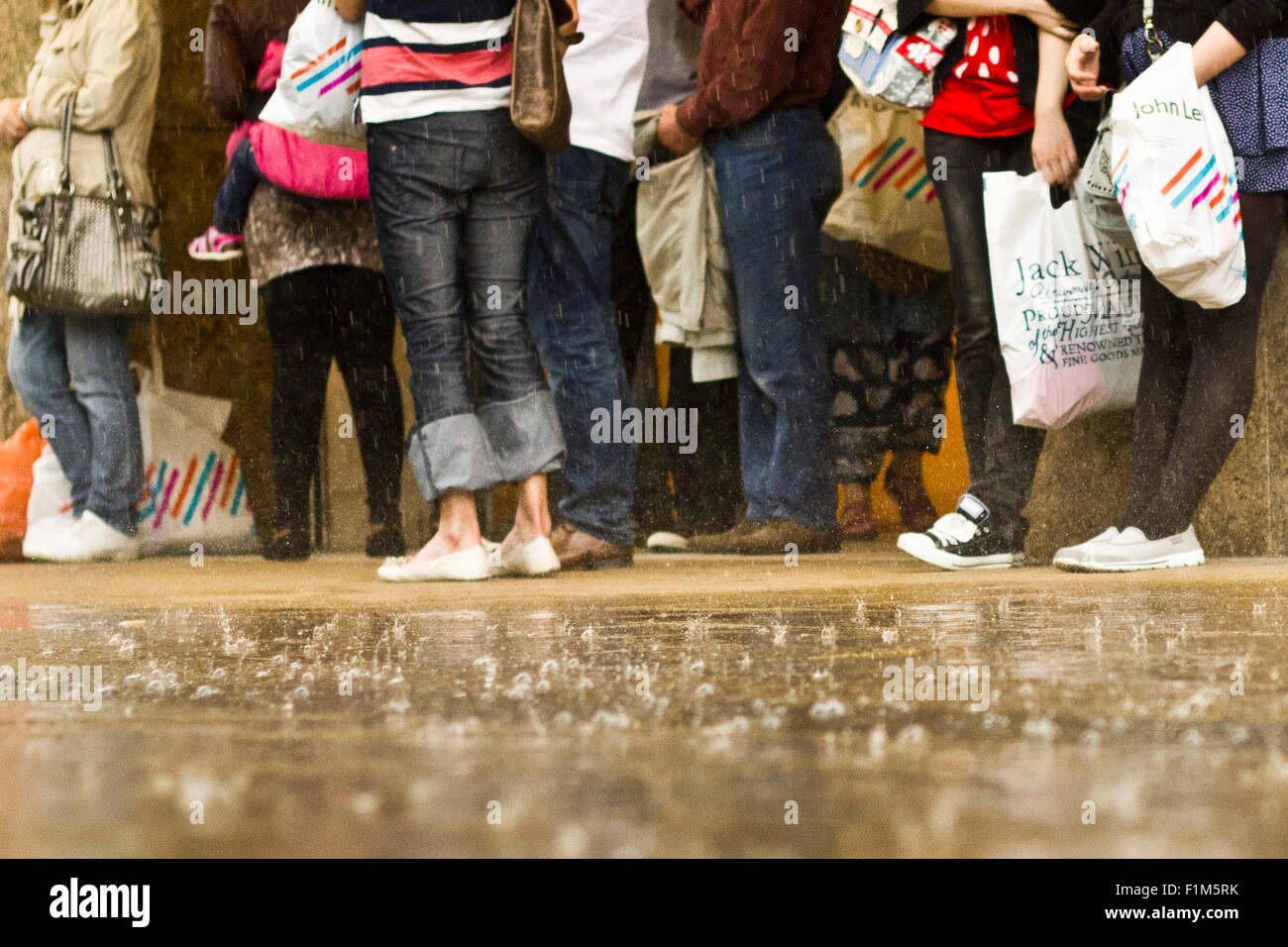 Shoppers hide from rain near shopping centre Stock Photo - Alamy