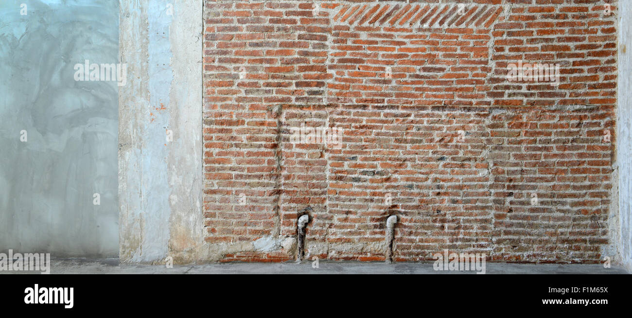 Old brick wall and pipe on concrete texture, background for decorate ...