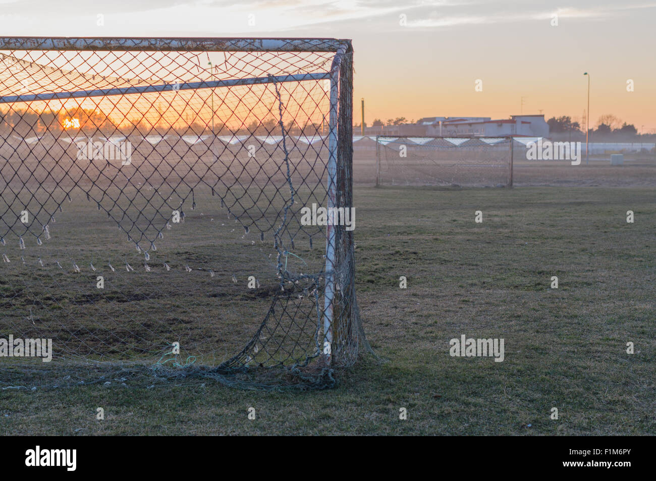 Abandoned soccer field and old rusty goals on sunset, nostalgia concept ...
