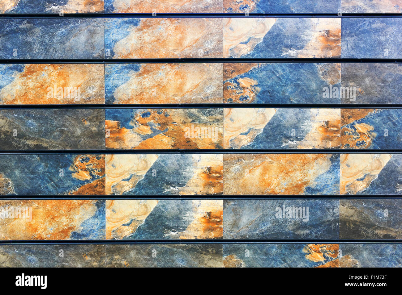 The wall is fixed by rectangular stone plates with yellow blue space ...