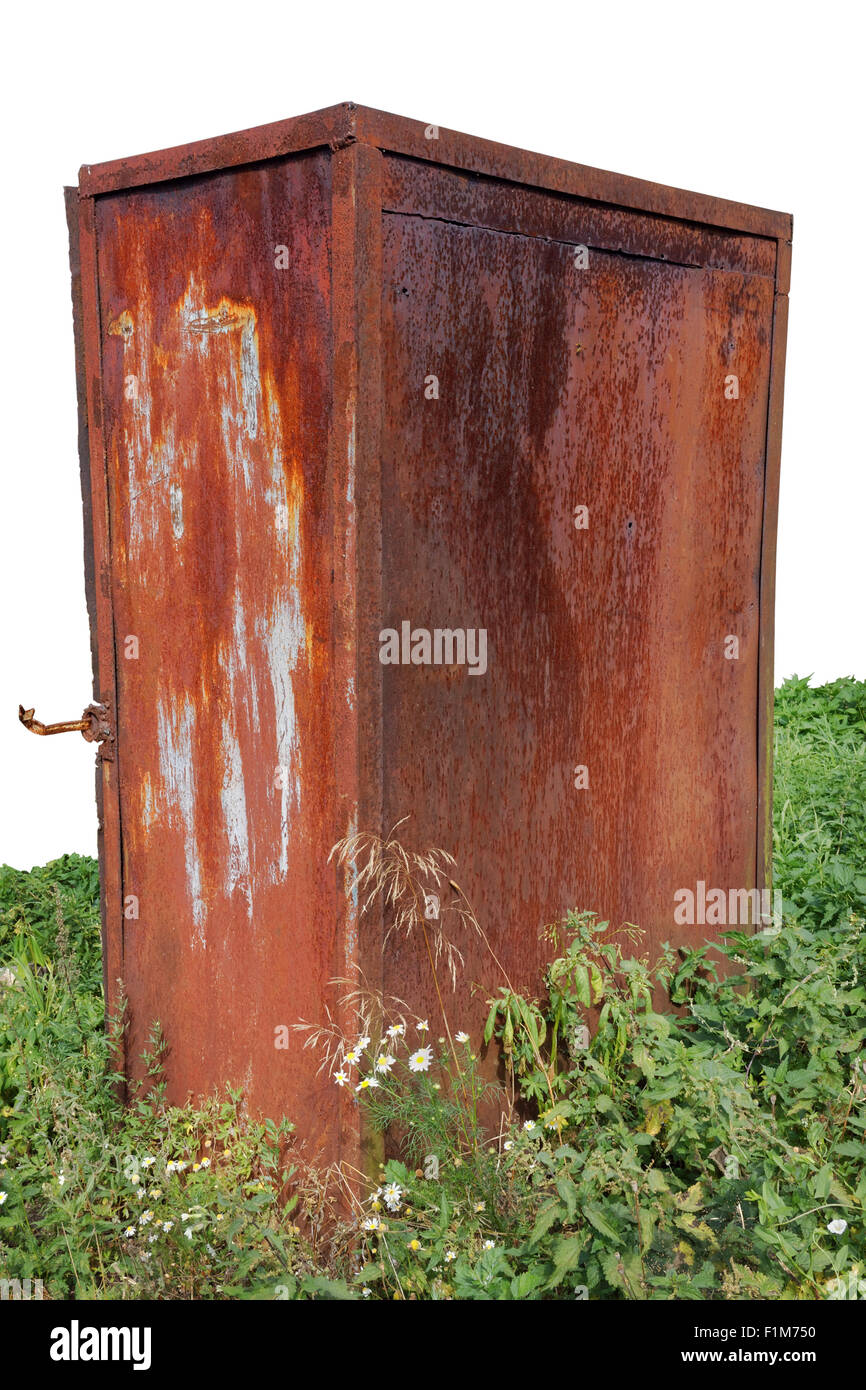 Lonely broken rusty safe in the wood on a green glade. Isolated Stock ...