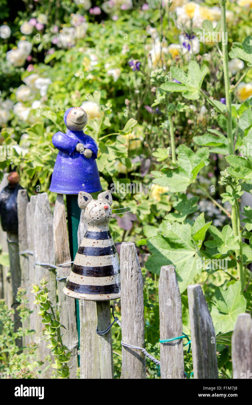Garden with wooden fence and figures Stock Photo - Alamy