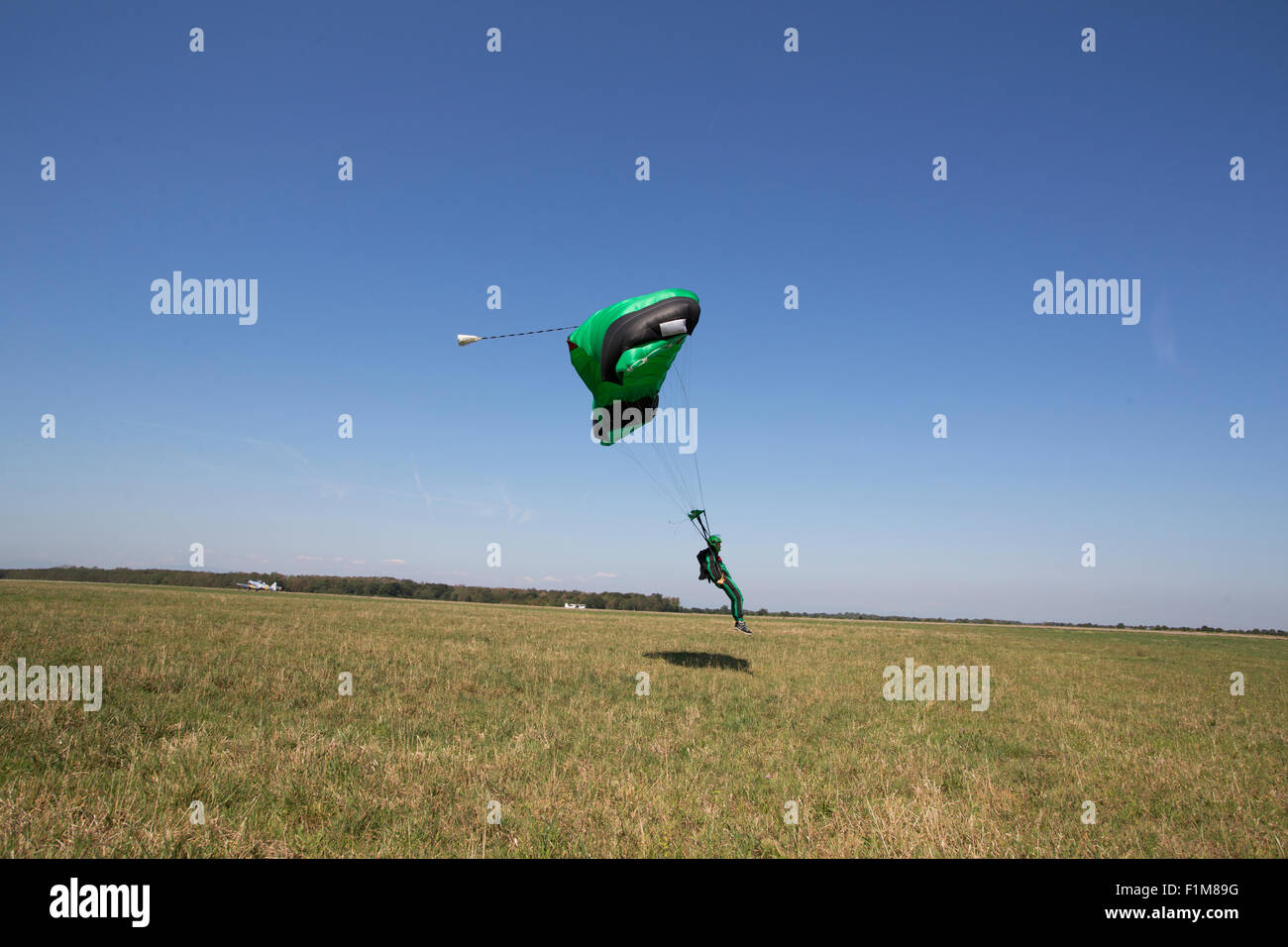 Skydiver under canopy is approaching the landing area after a fun ...