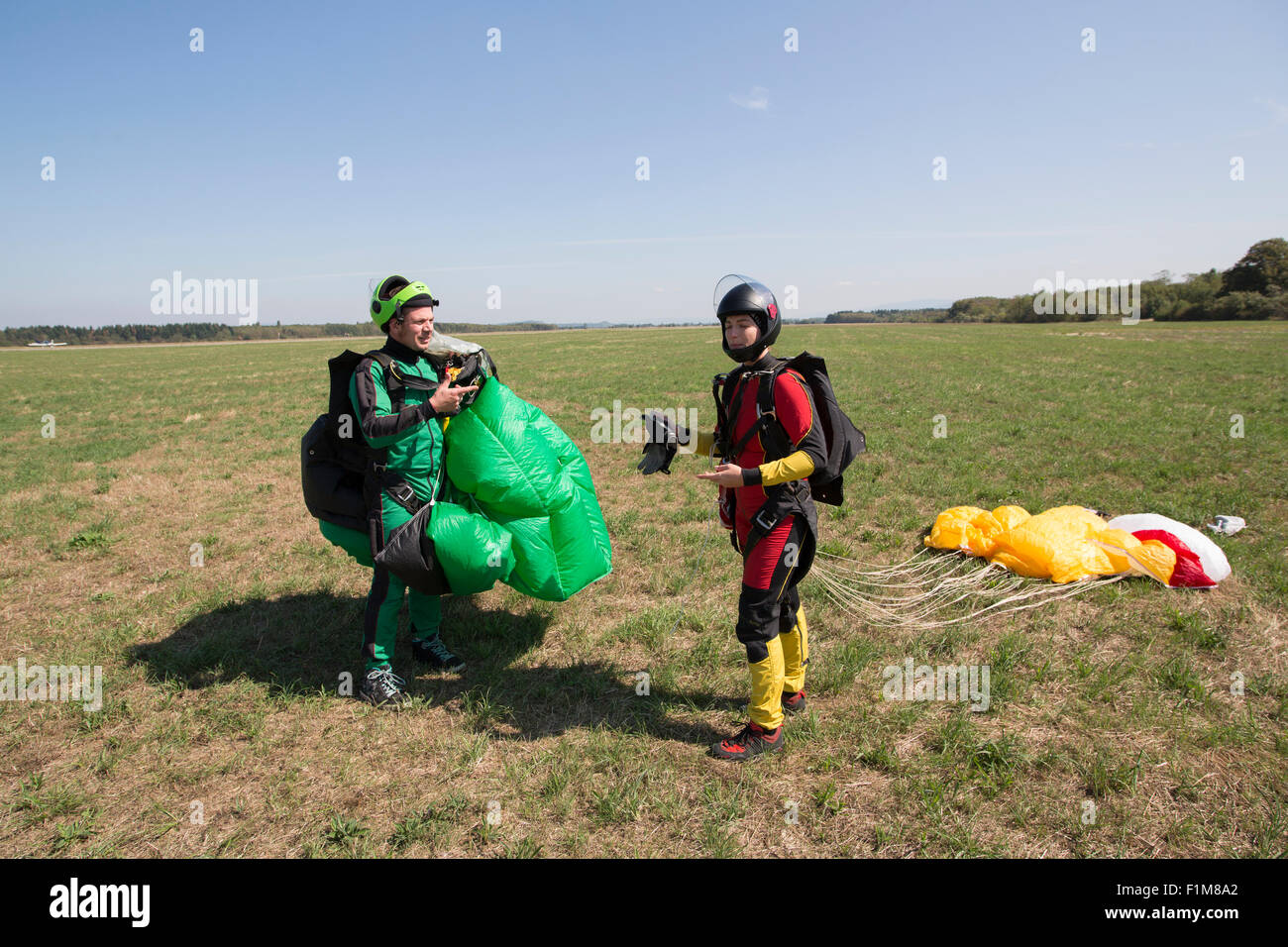 These two skydivers landed with their parachute and now very happy to ...