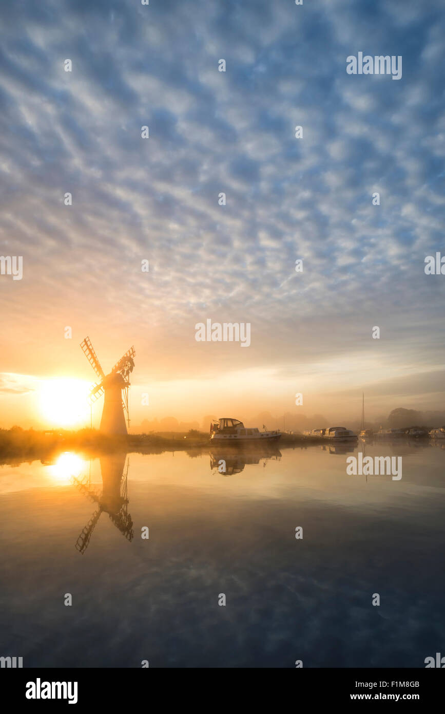 Stunning landscape of windmill and river at sunrise on Summer morning ...