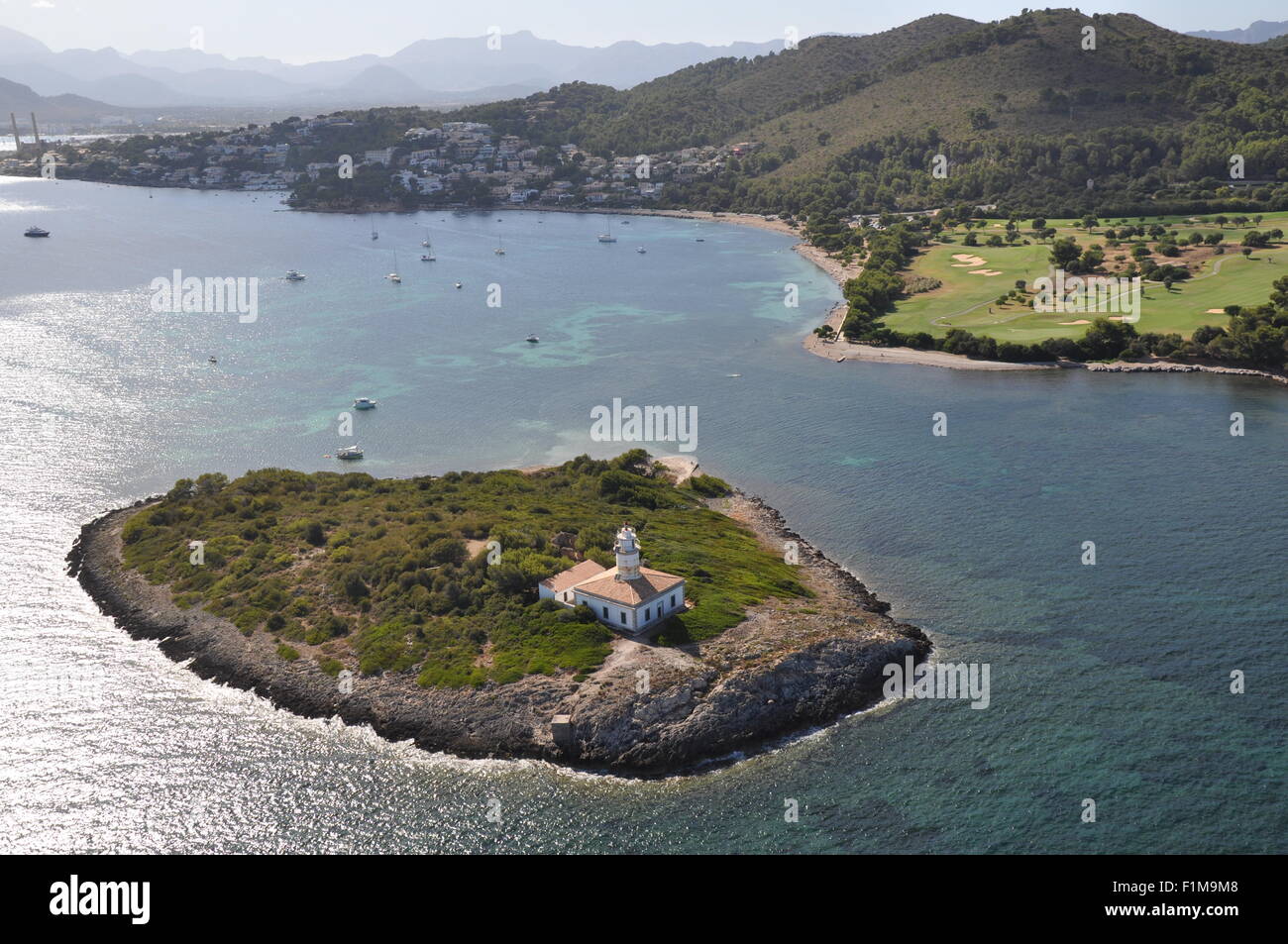 Aerial view of Alcanada Lighthouse and Island in Alcudia Bay, Mallorca ...