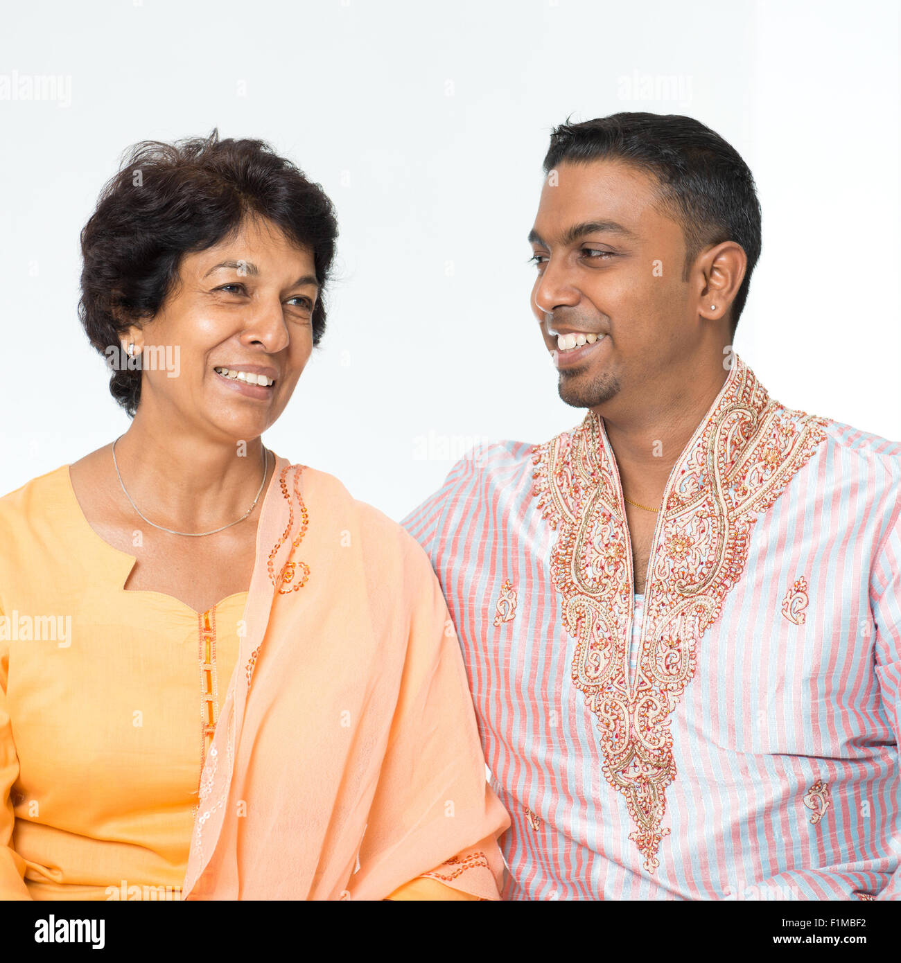 Portrait of happy Indian family communicating at home. Mature 50s ...