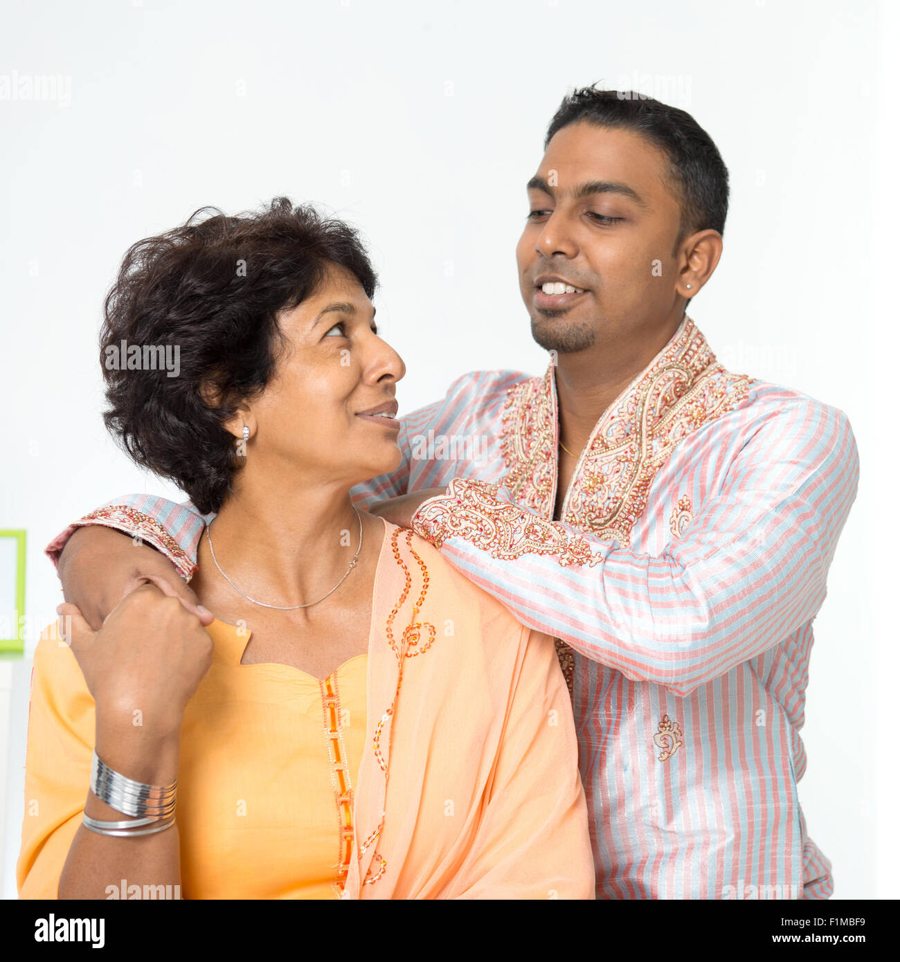 Portrait of happy Indian family interacting at home. Mature 50s Indian ...