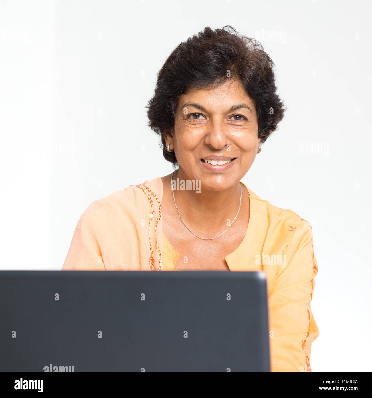 Elder people and modern technology concept. Portrait of a 50s Indian ...