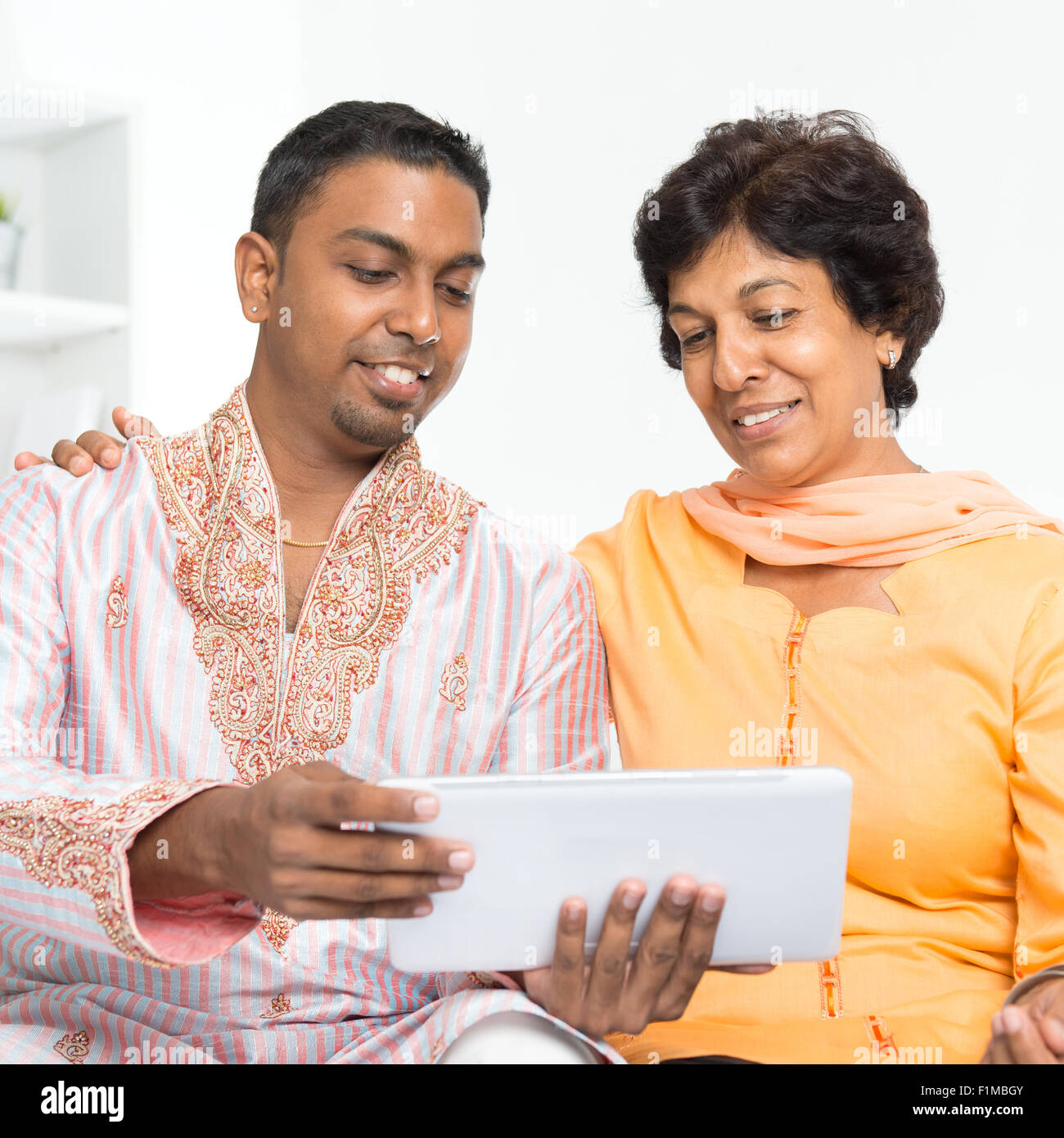 Portrait of Indian family using social media at home. Mature 50s Indian ...