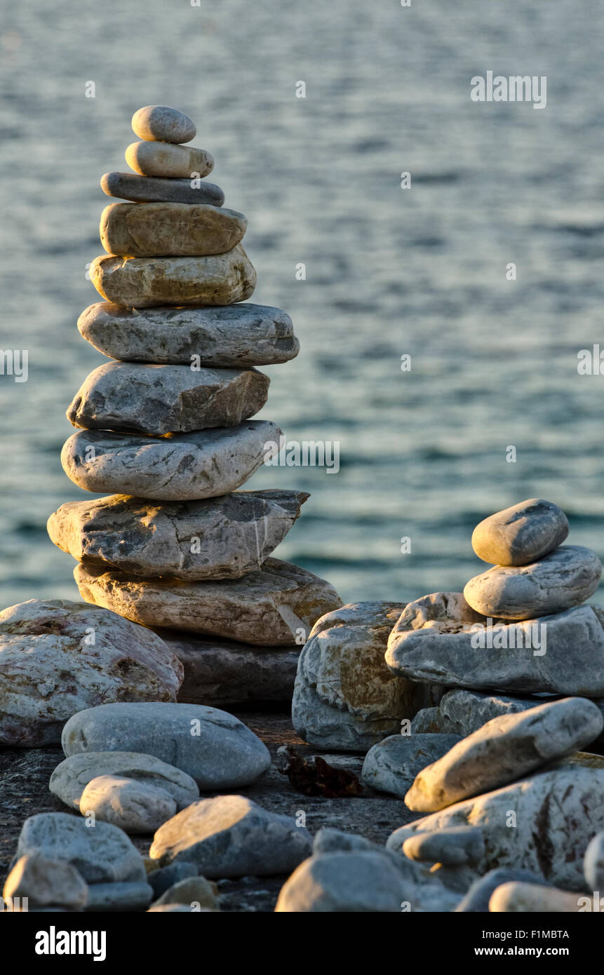man made pile of flat stones side lit Stock Photo - Alamy
