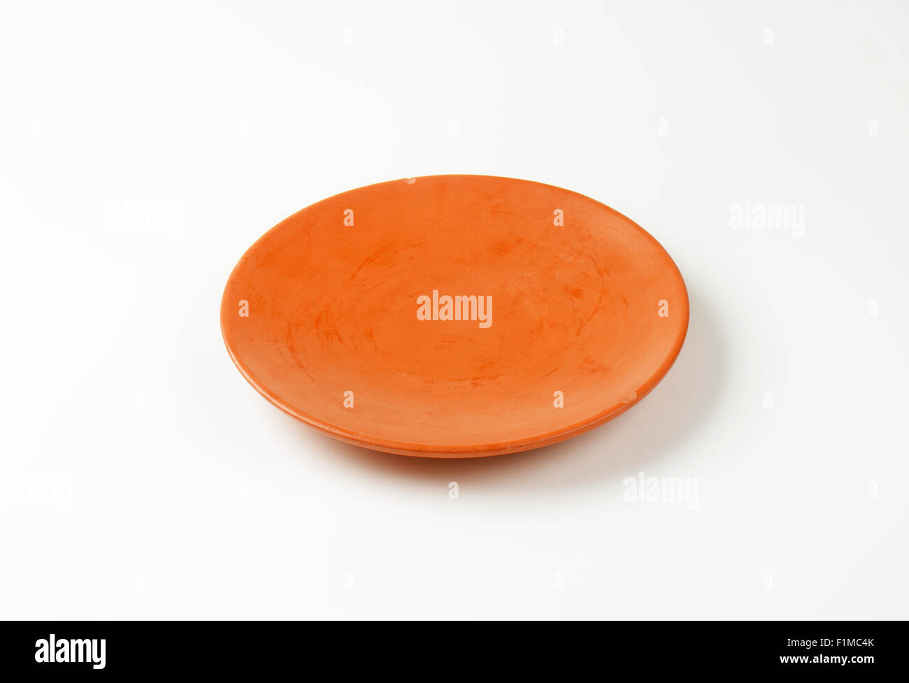 empty orange plate on white background Stock Photo - Alamy