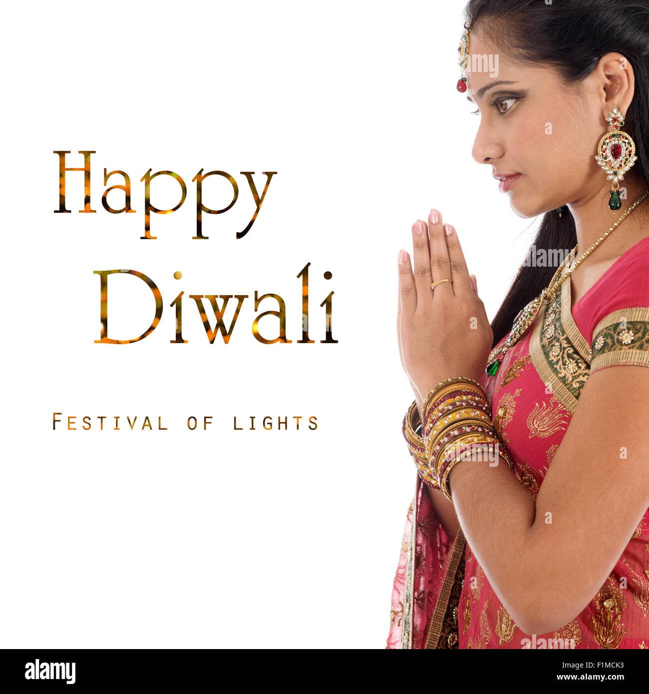Indian woman in traditional sari praying and celebrating Diwali or ...