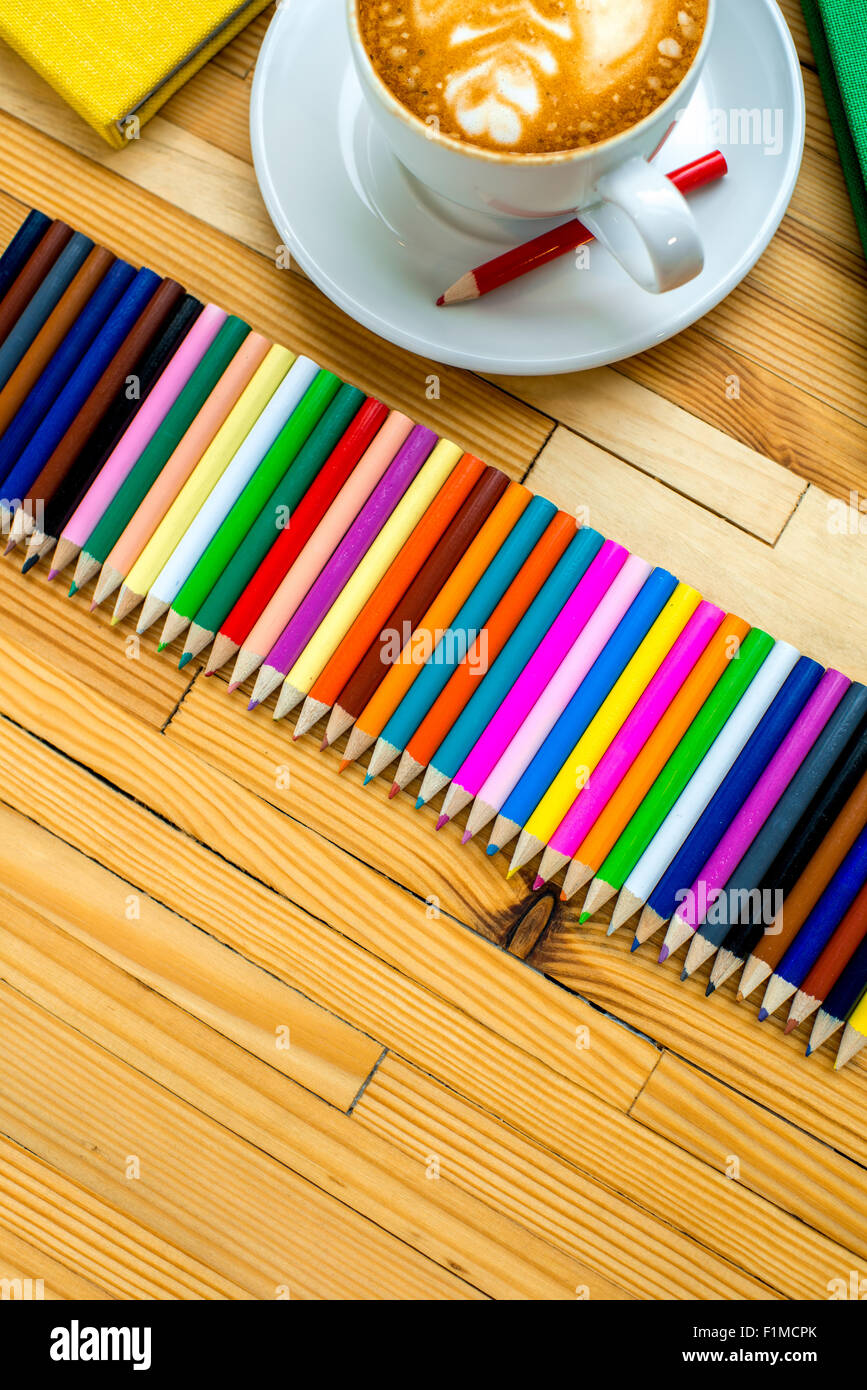 Colorful pencils with books and coffee Stock Photo - Alamy
