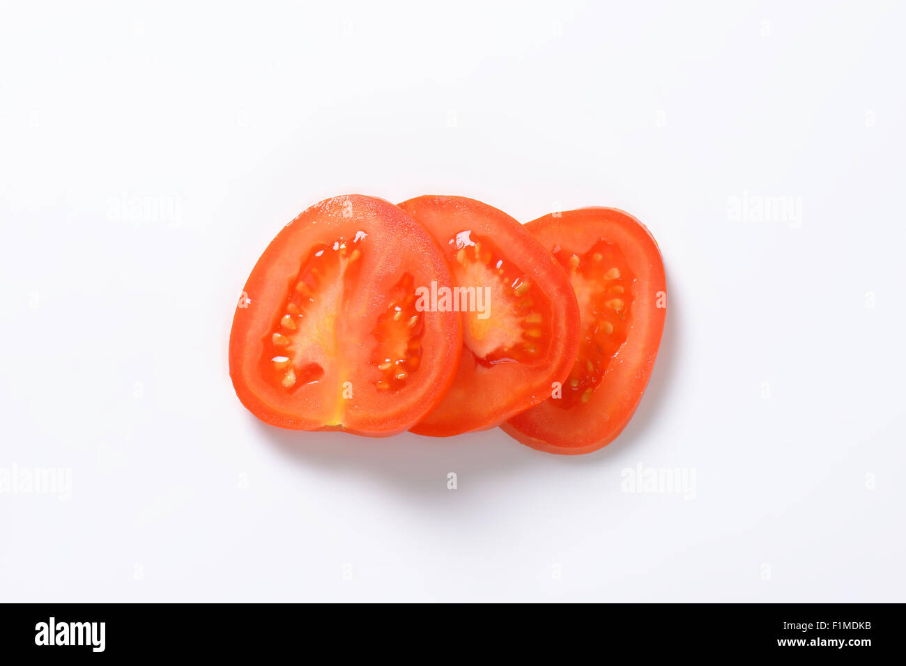 sliced tomato on white background Stock Photo - Alamy
