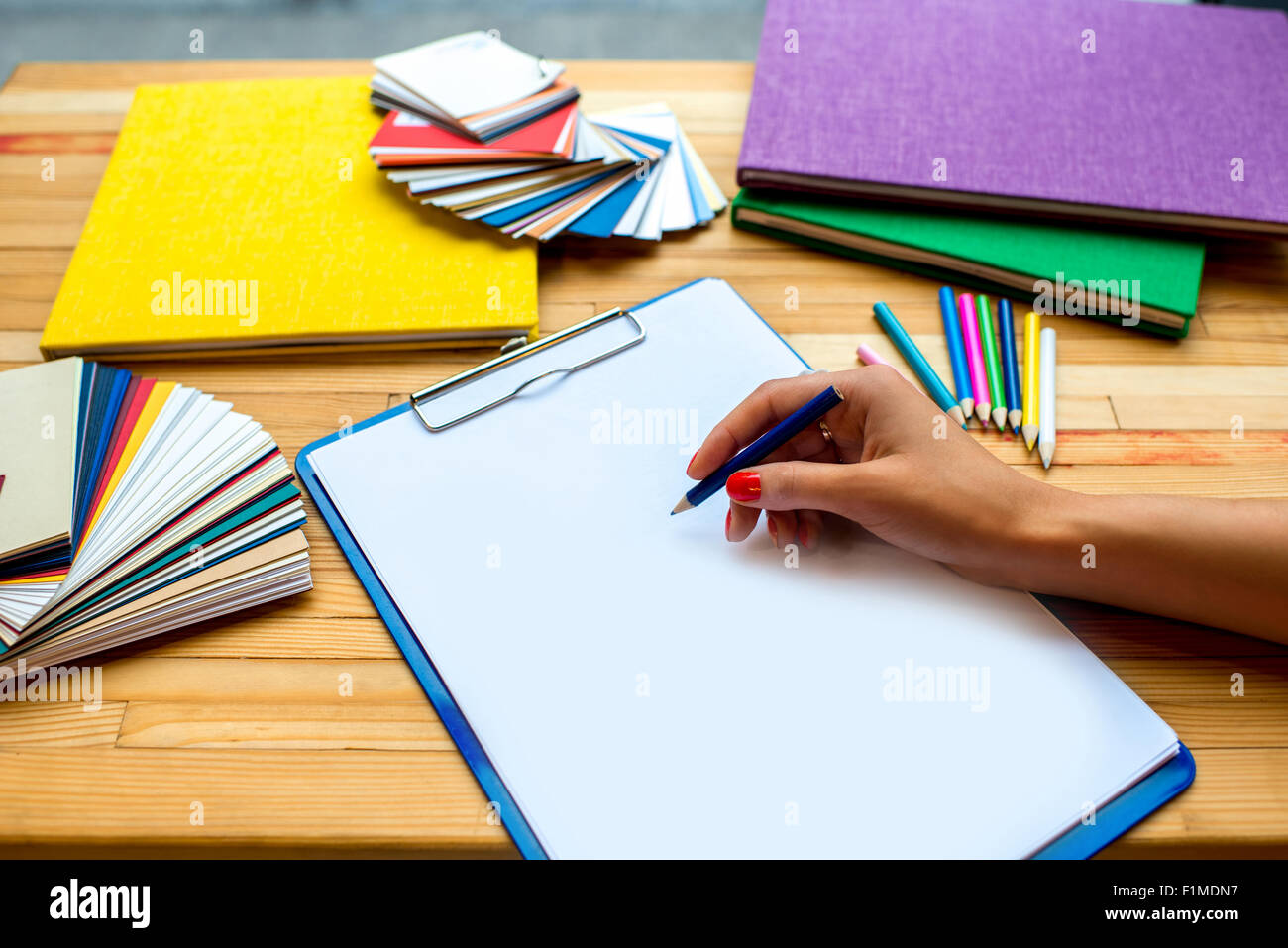 Writing with color pencil on the white sheet of paper Stock Photo - Alamy