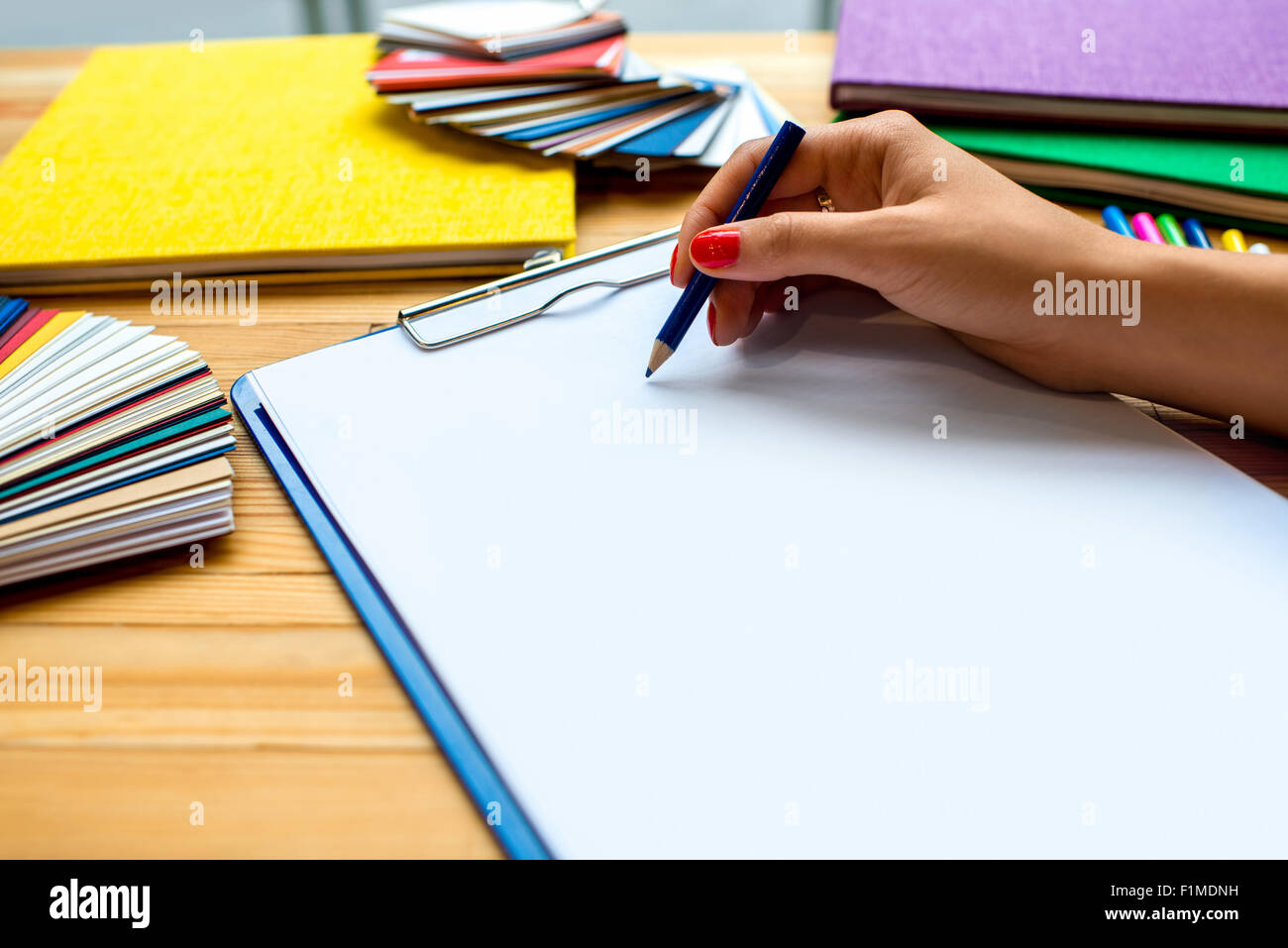 Writing with color pencil on the white sheet of paper Stock Photo - Alamy