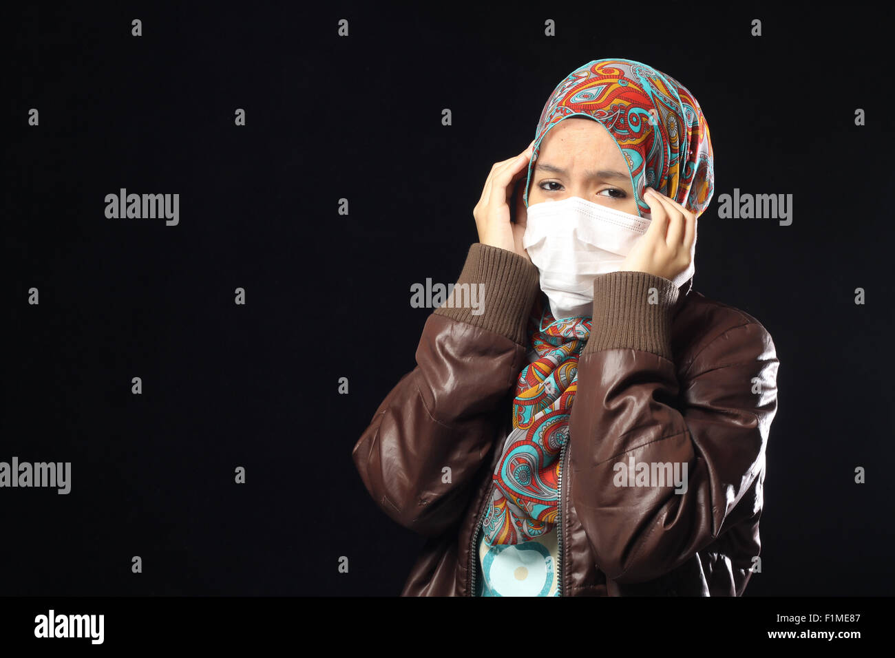 muslim woman wearing disposable face mask on black background Stock ...