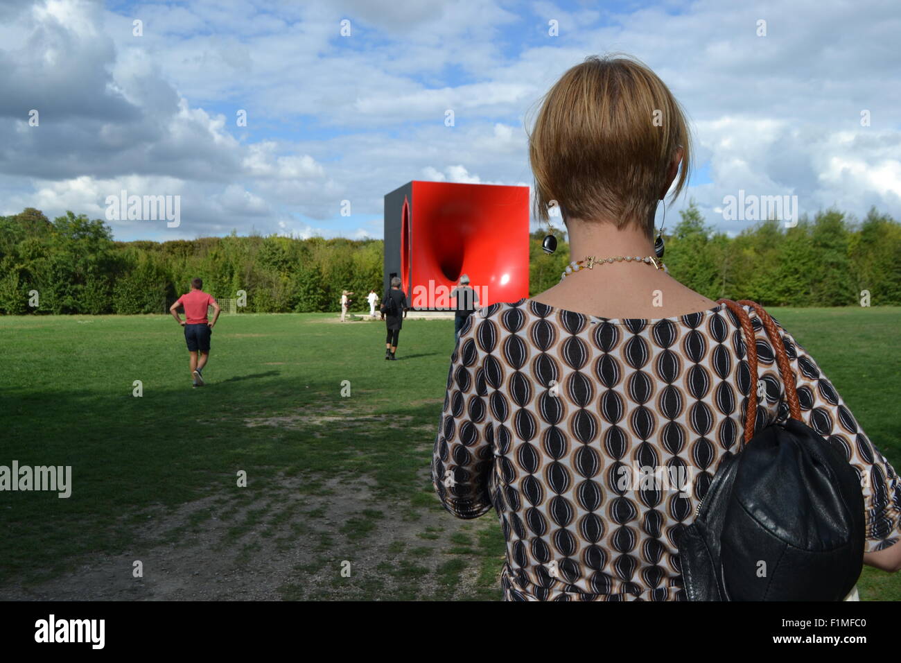 Visitors approach art work by Anish Kapoor in Versailles. The work is ...