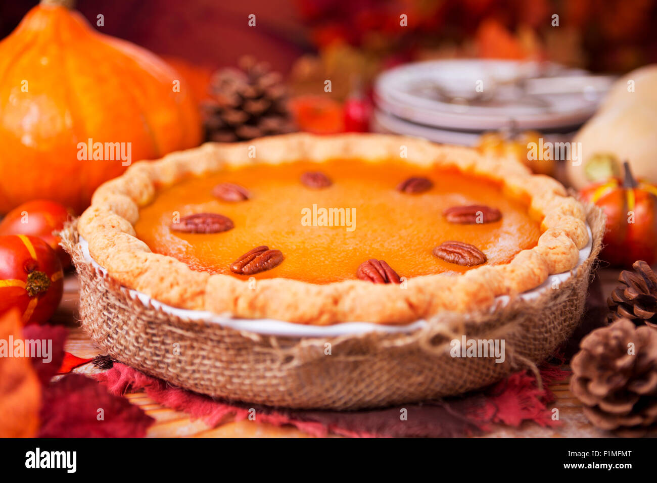 A delicious homemade pumpkin pie on a rustic table with autumn ...