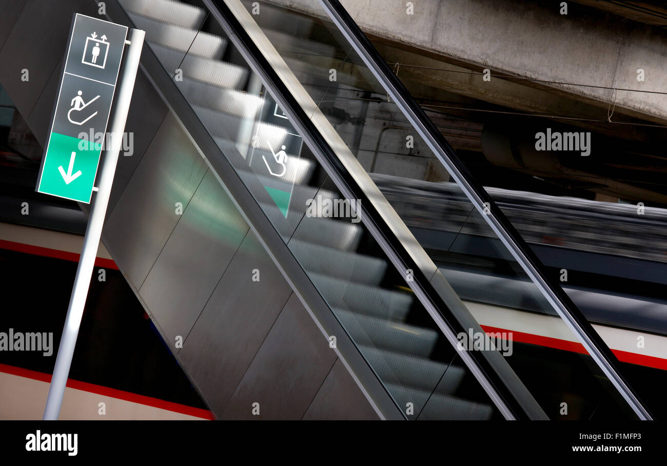 Signpost and escalators in a railway station horizontal Stock Photo - Alamy