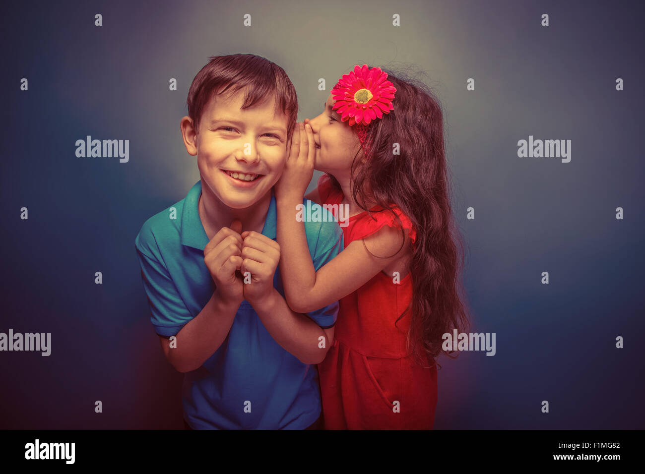 Girl whispering in boy's ear hi-res stock photography and images - Alamy
