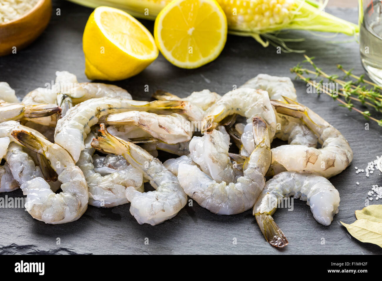 Raw peeled shrimp with tails with lemon on sutting board Stock Photo ...