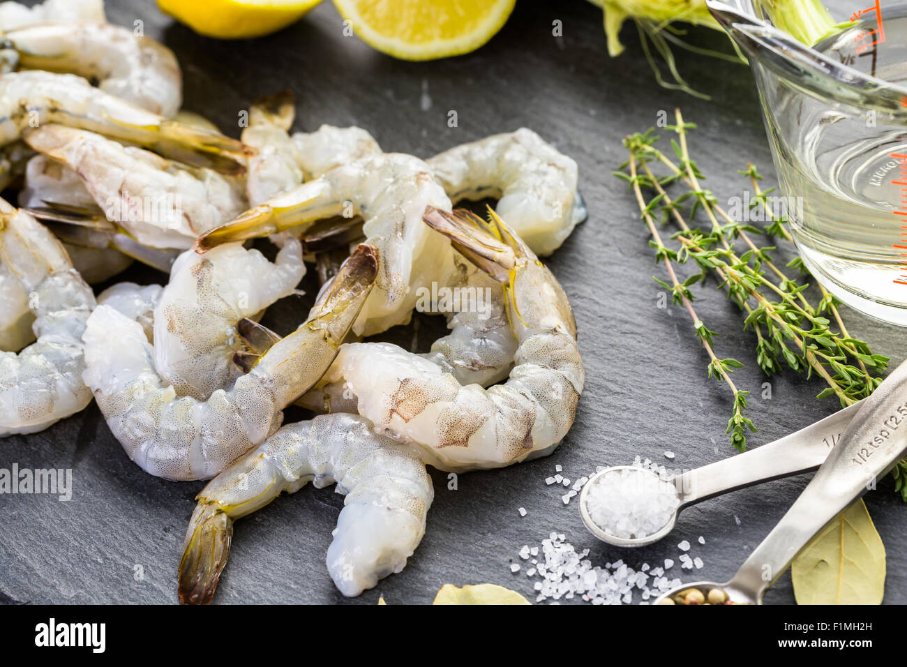 Raw peeled shrimp with tails with lemon on sutting board Stock Photo ...
