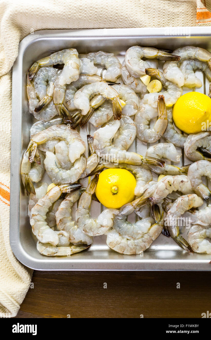 Raw peeled shrimp with tails with lemon ready for roasting Stock Photo ...