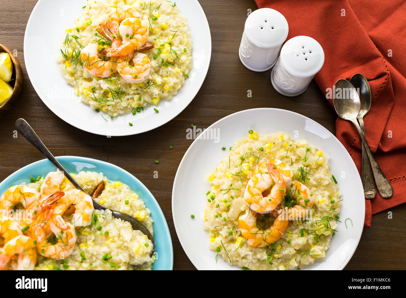Homemade corn risotto with roasted shrimp on dining table Stock Photo ...