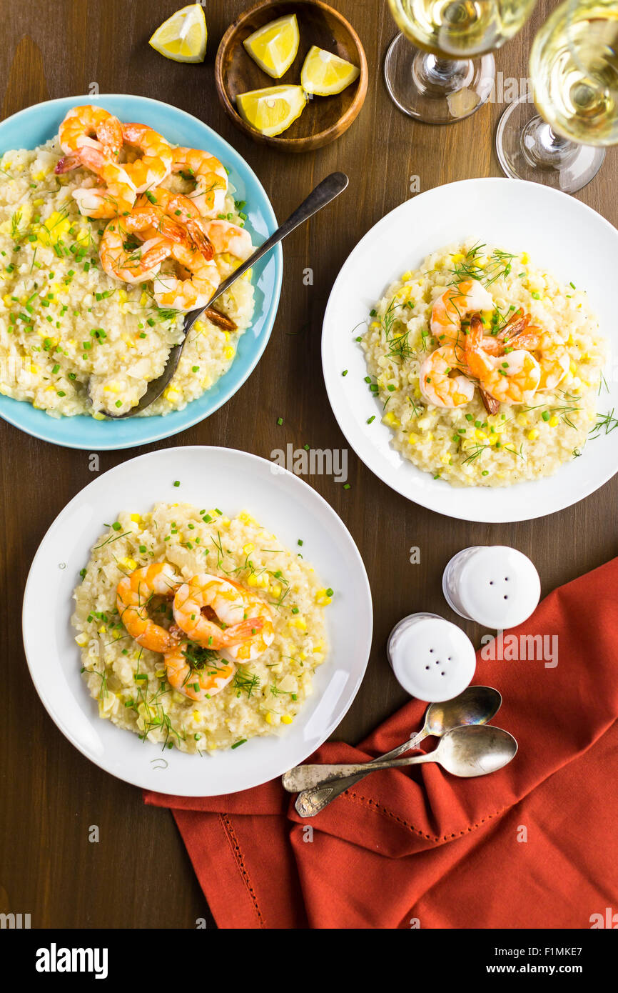Homemade corn risotto with roasted shrimp on dining table Stock Photo ...